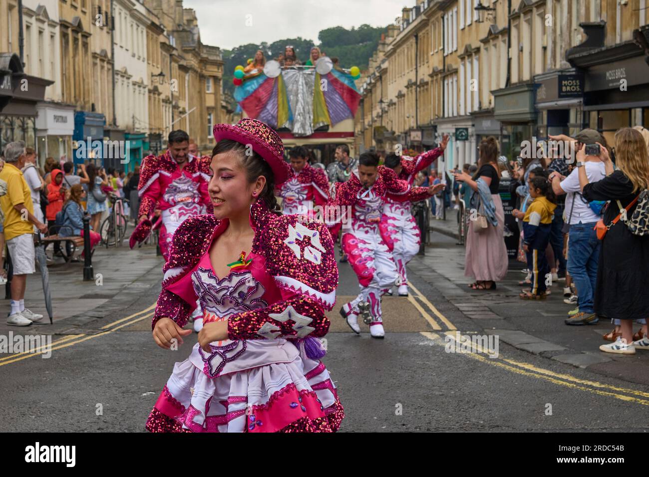 Dancers and musicians dressed in ornate costumes parade through the ...