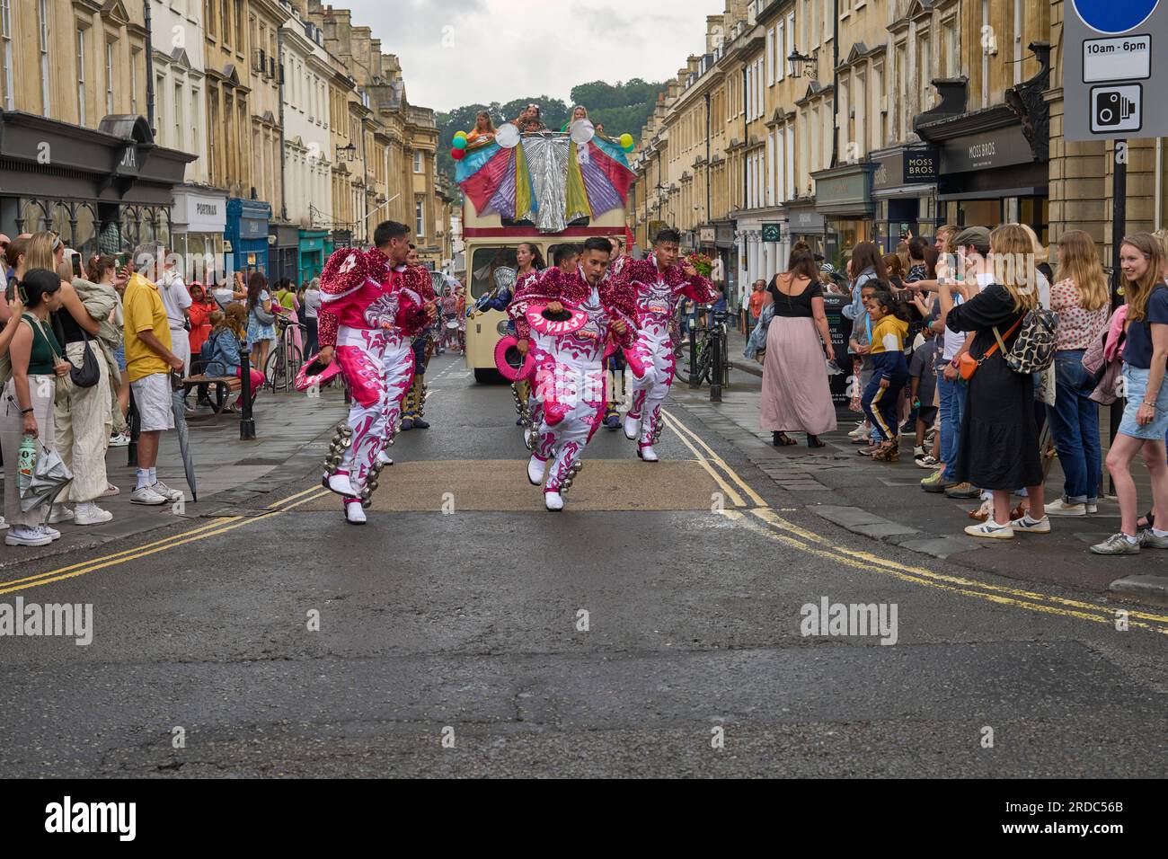 Dancers and musicians dressed in ornate costumes parade through the ...
