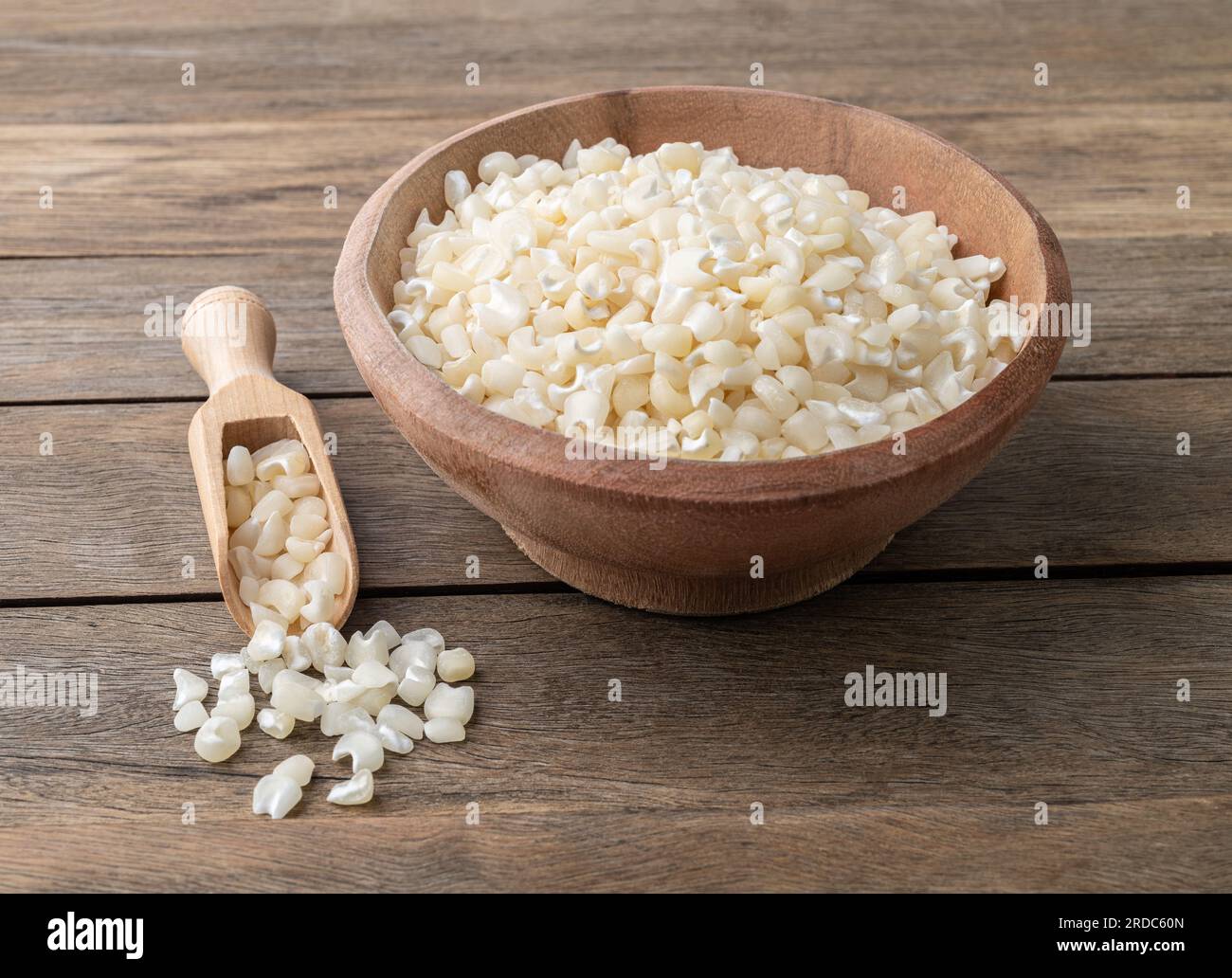 Dried canjica, hominy or white corn on a bowl over wooden table Stock ...