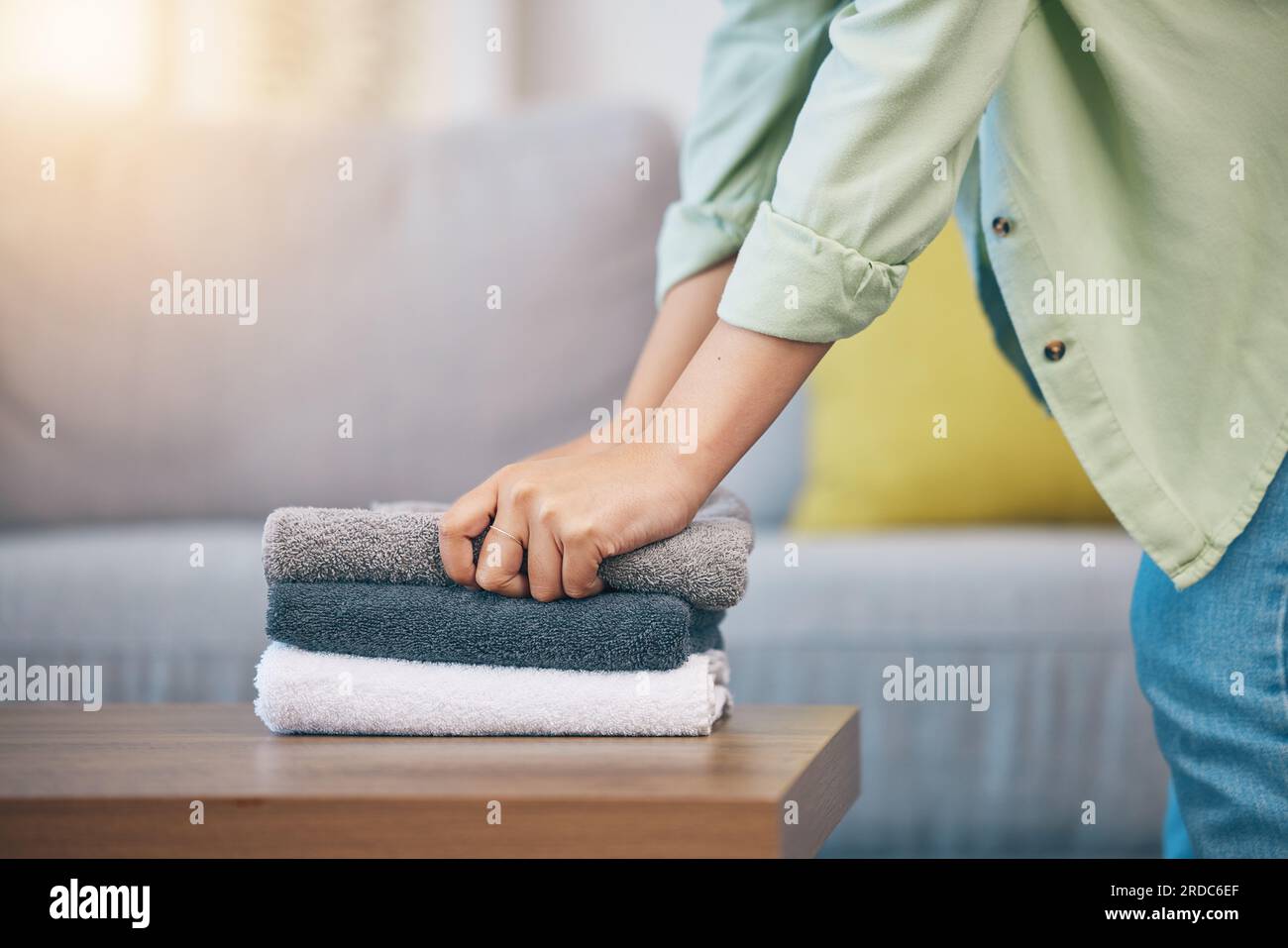 Hands, home and laundry on living room table for hygiene, cleaning and ...