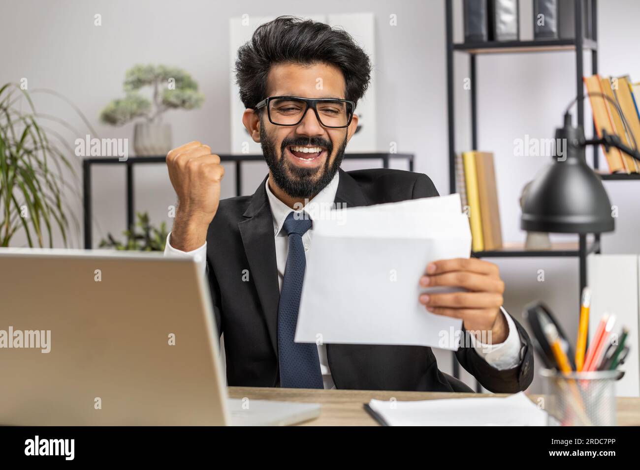 Indian business man open envelope letter, reading it. Career growth ...