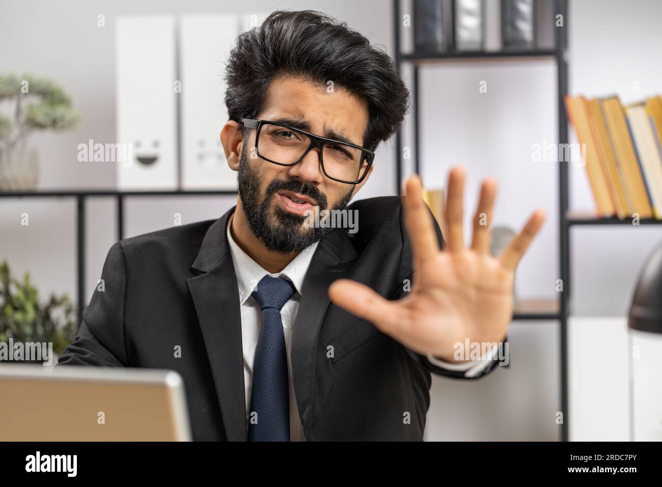 Stop. Indian businessman guy working on laptop, warning of finish ...