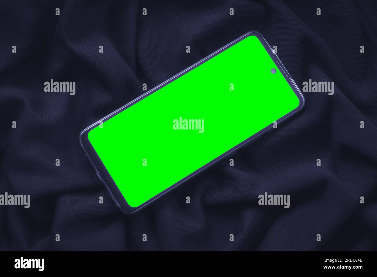 Smartphone With Green Screen On Wrinkled Fabric. Modern Device On ...