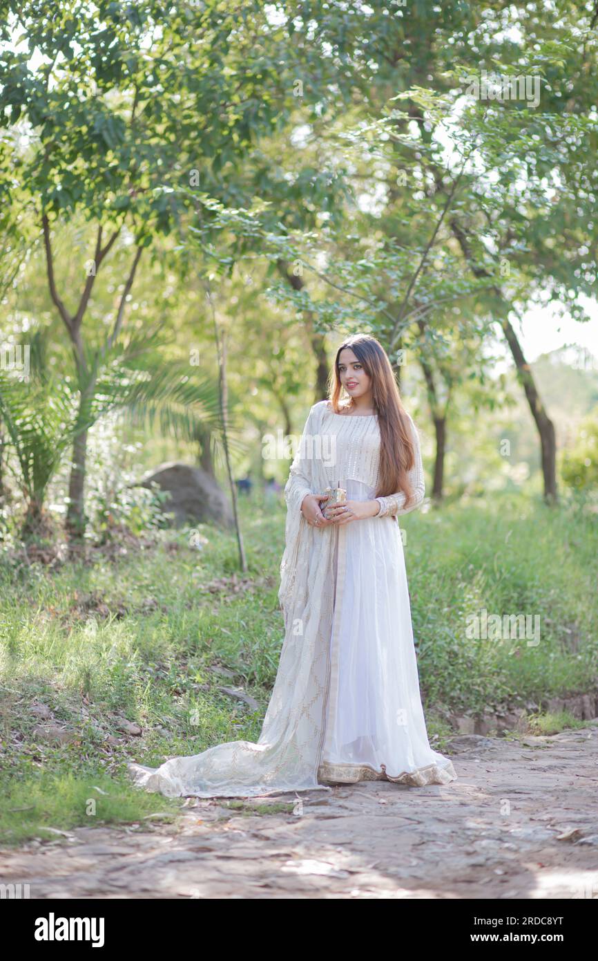 Beautiful Asian Girl posing in front of trees and giving pose. The ...