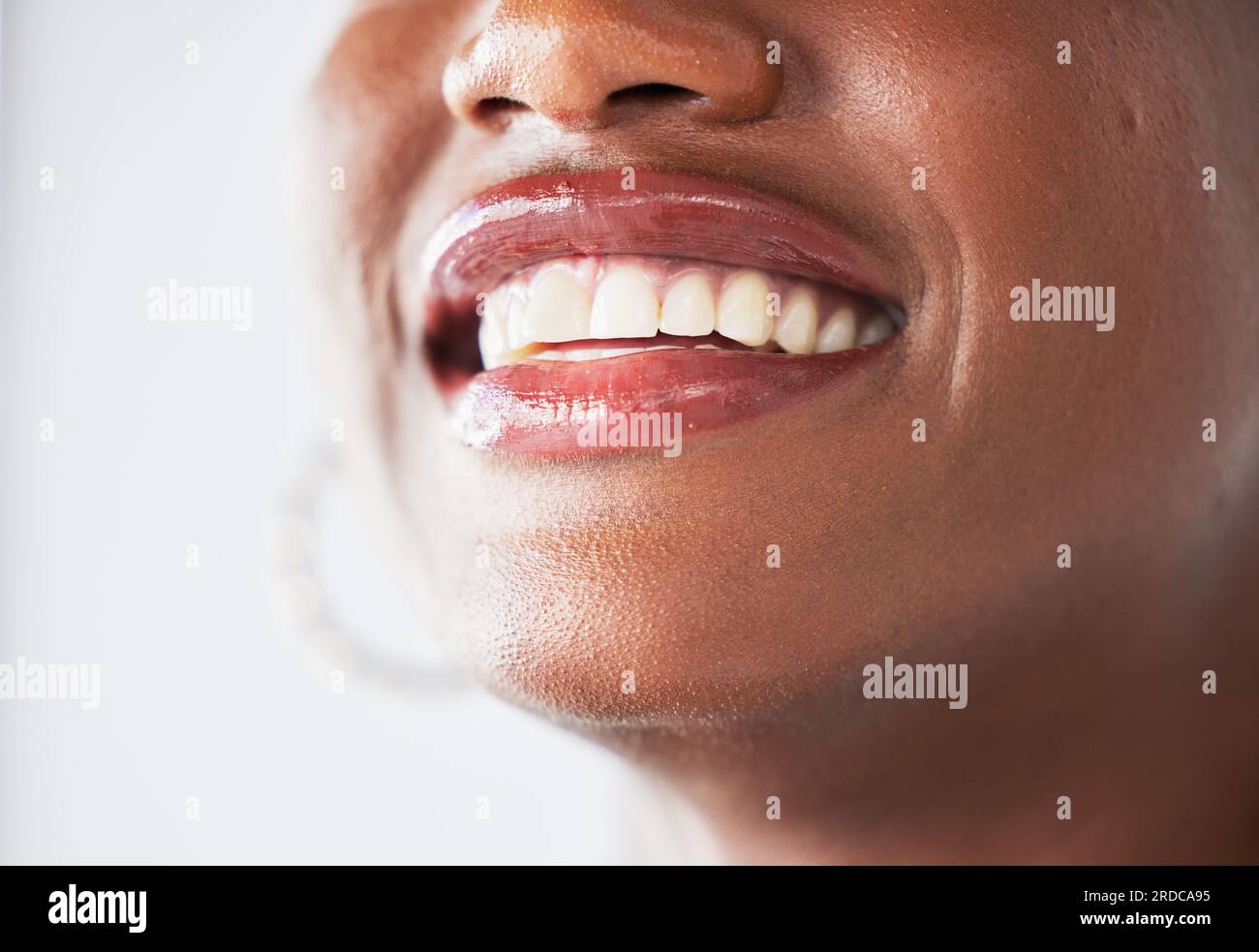 Happy, lips and beauty with a woman closeup in studio on a gray ...