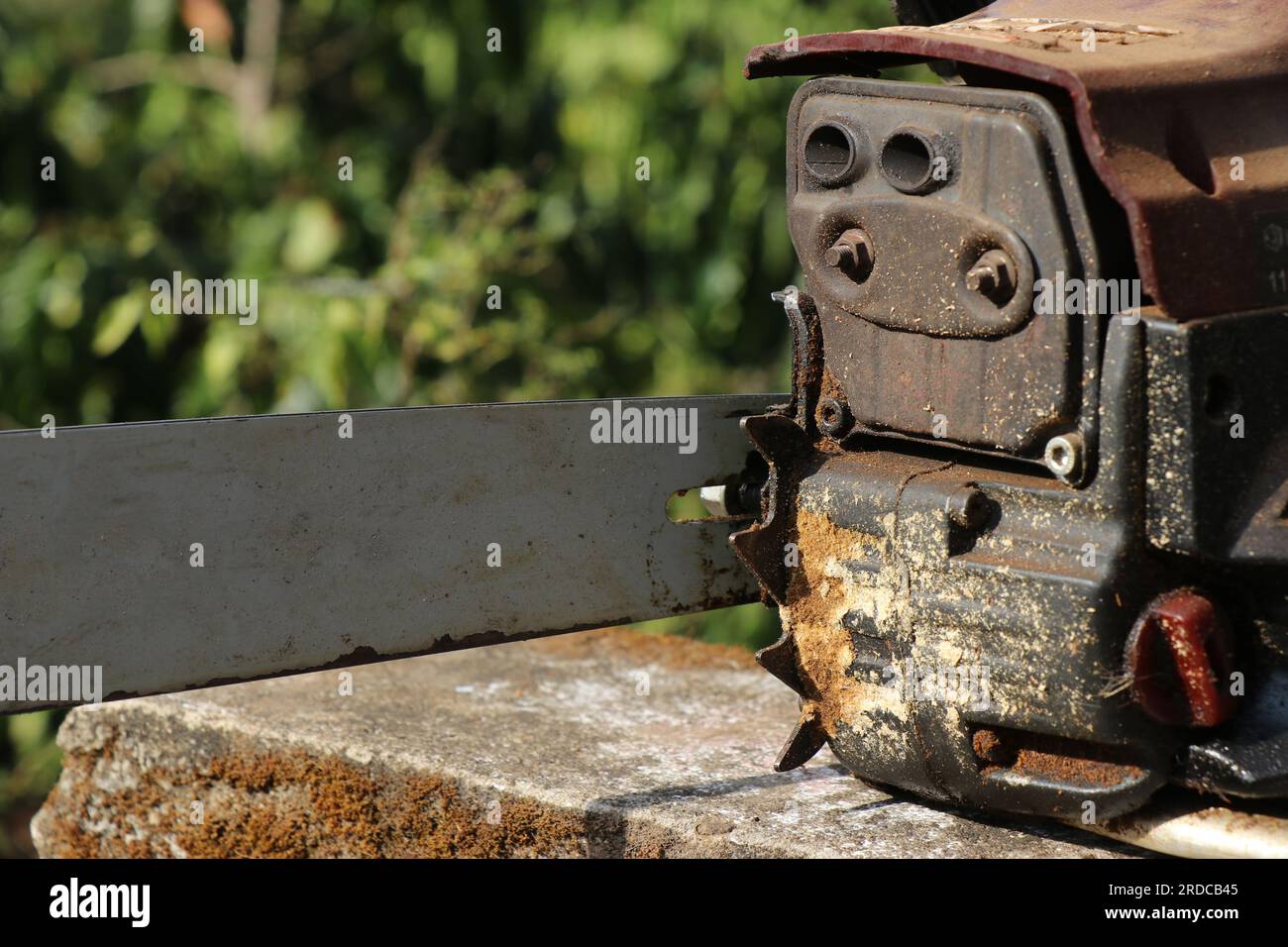 Old gasoline powered woodcutting machine with a view of its rusty ...