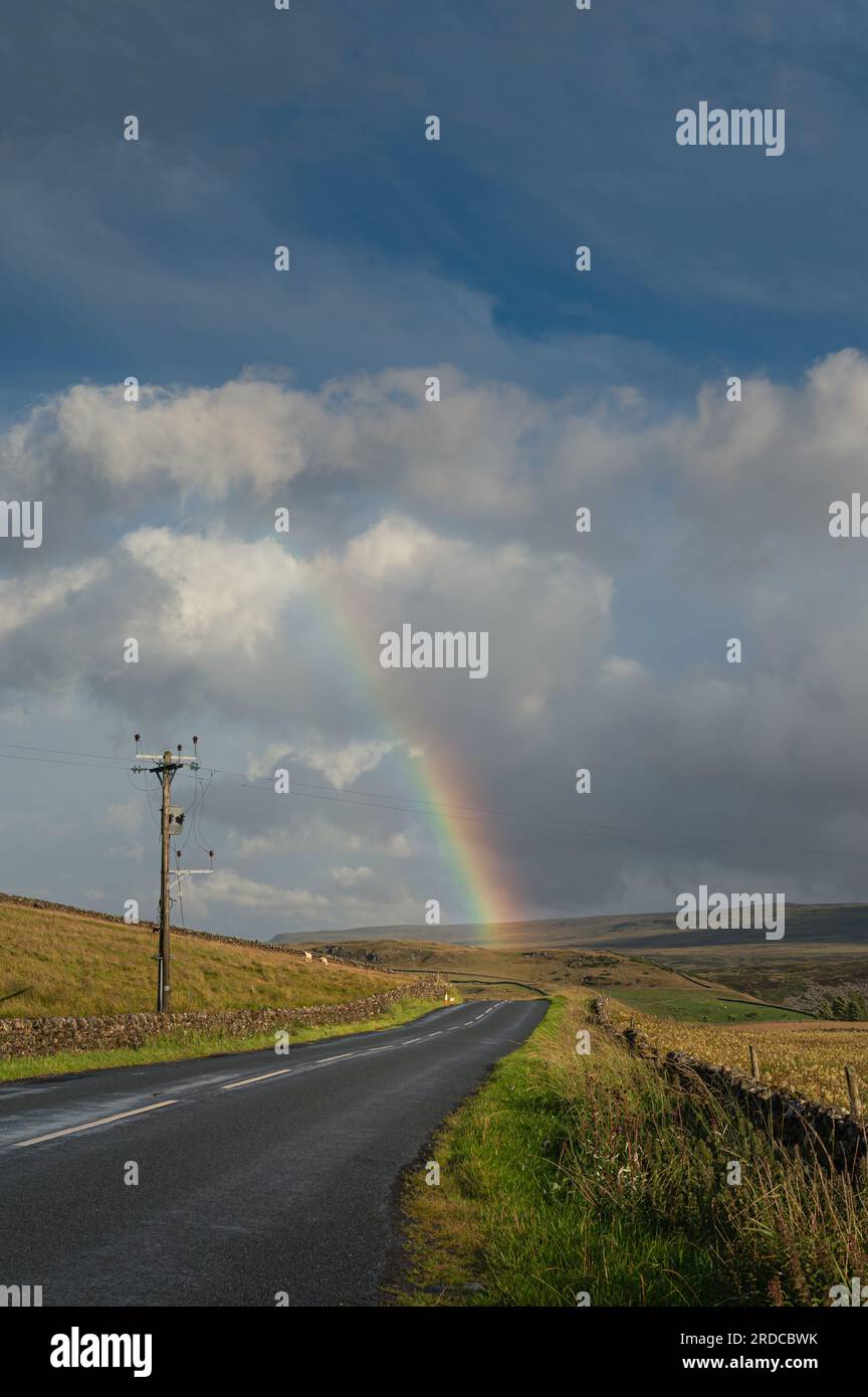 Rainbow over the North Pennines. Fields lit by transient light Stock ...