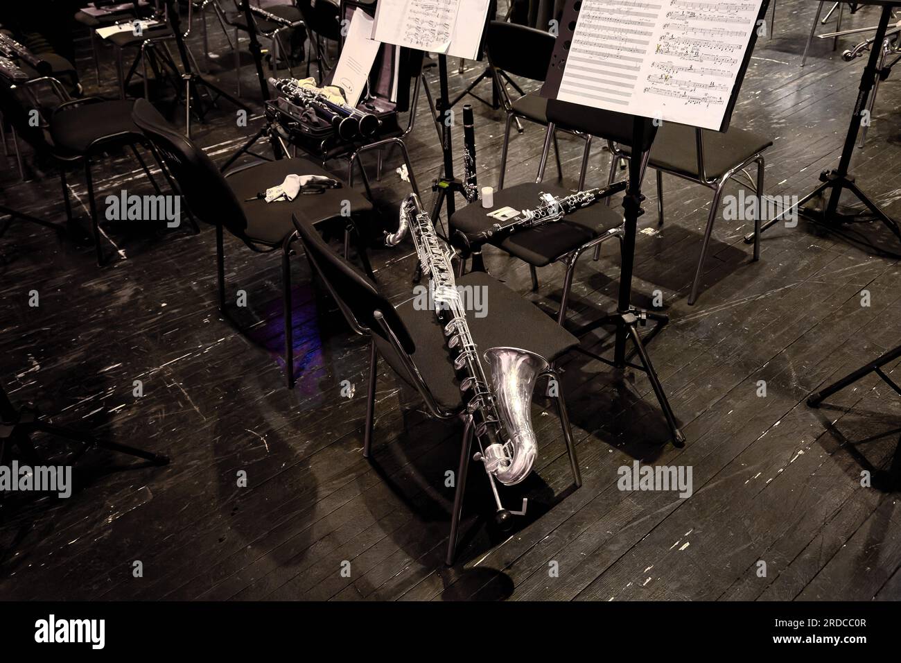 Image of wind musical instruments lie on chairs in the orchestra pit ...