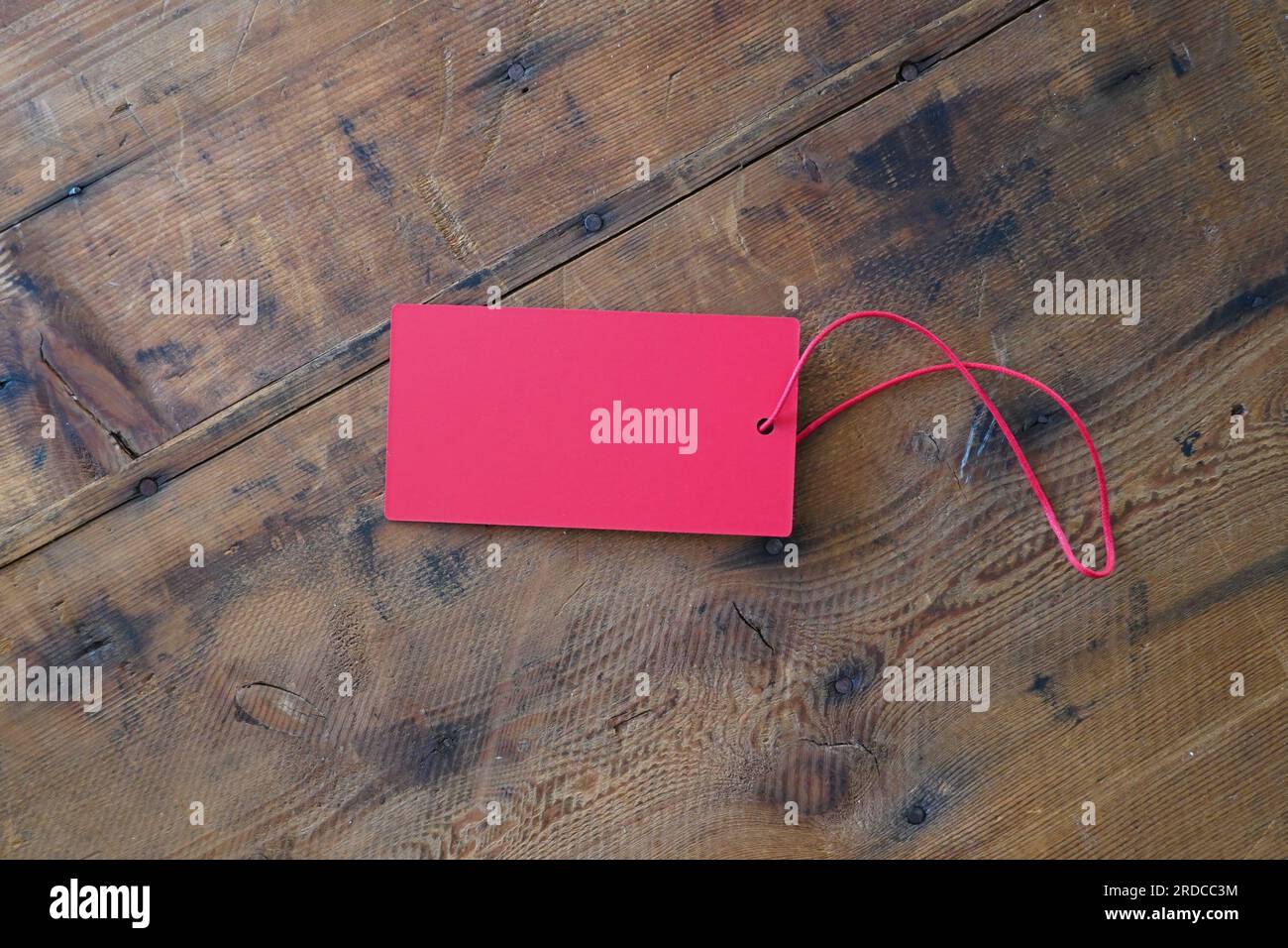 Red paper tag with string hi-res stock photography and images - Alamy