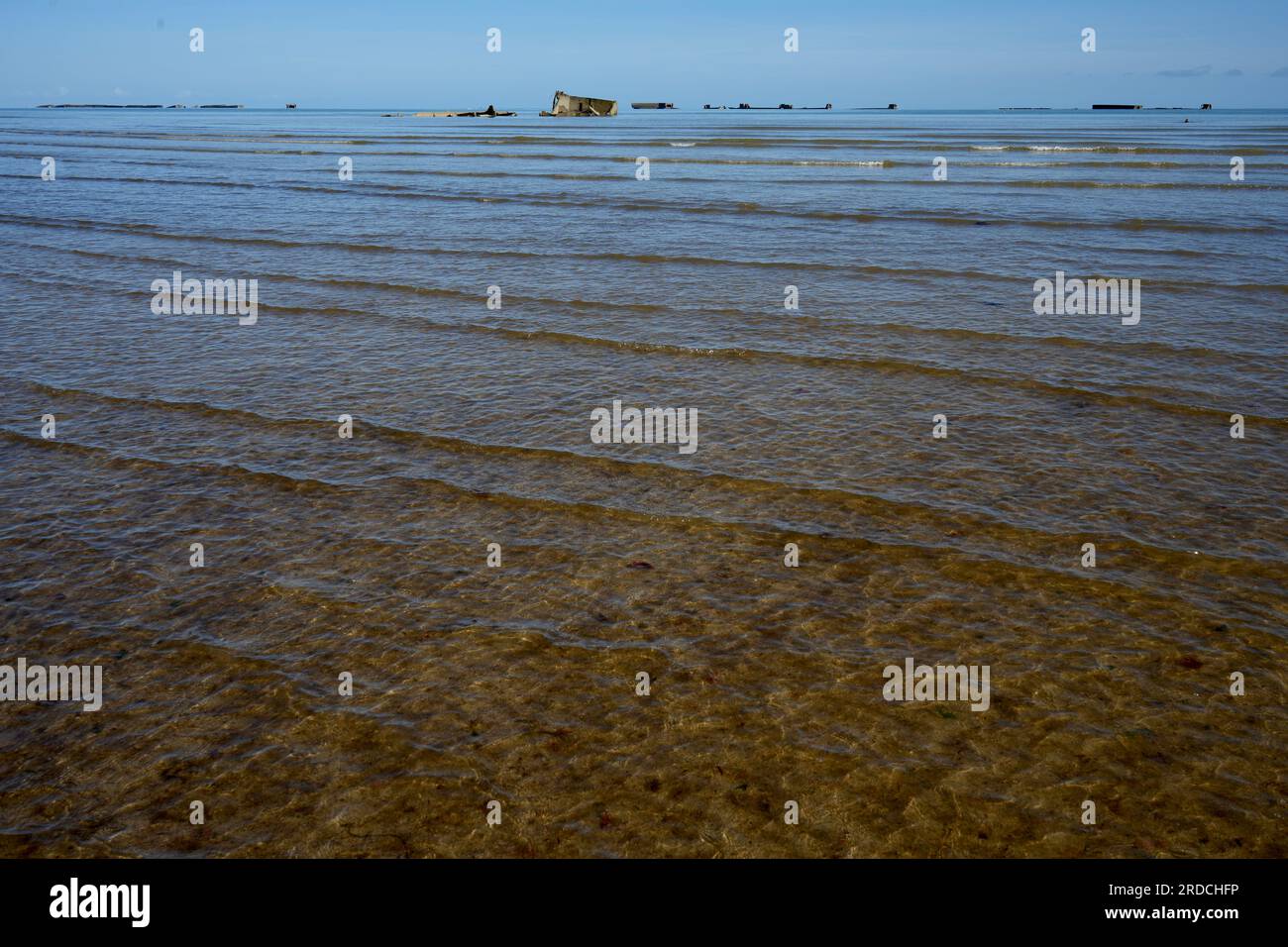 Waves lapping on the beach with Remains of the WW2 D-Day Mulberry ...