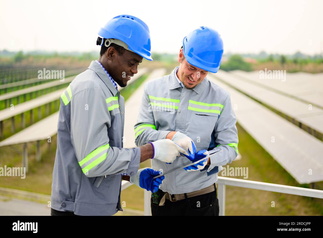Happy maintenance engineers checking and maintaining solar panels Stock ...