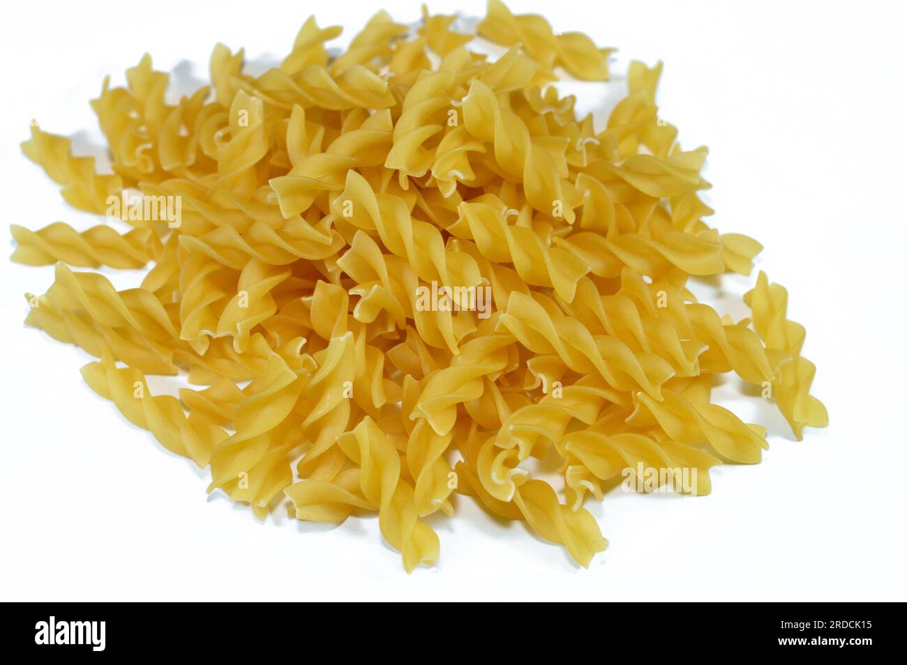 Pile of dry raw uncooked Macaroni, dry pasta shaped like fusilli, Made ...