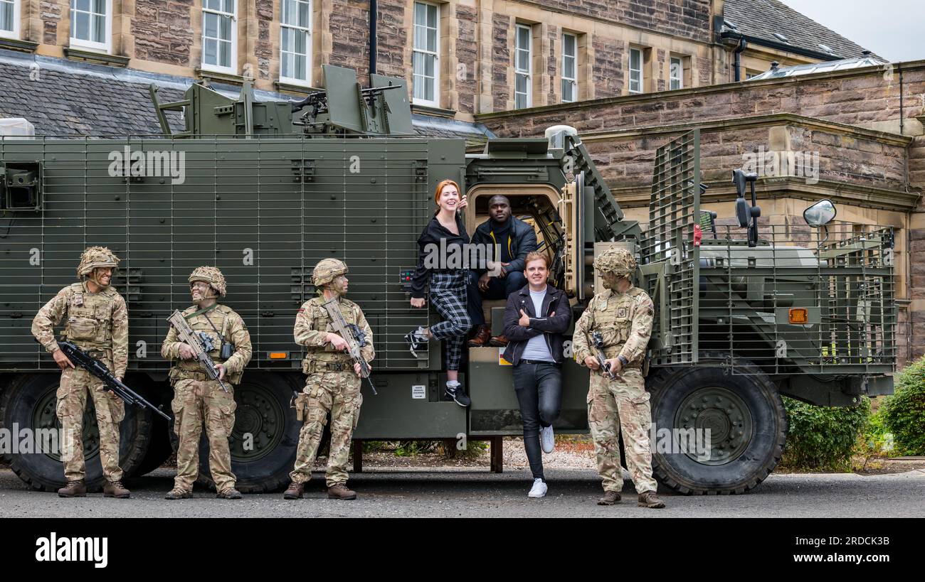 Frnge performers with British soldiers & Mastiff military vehicle ...