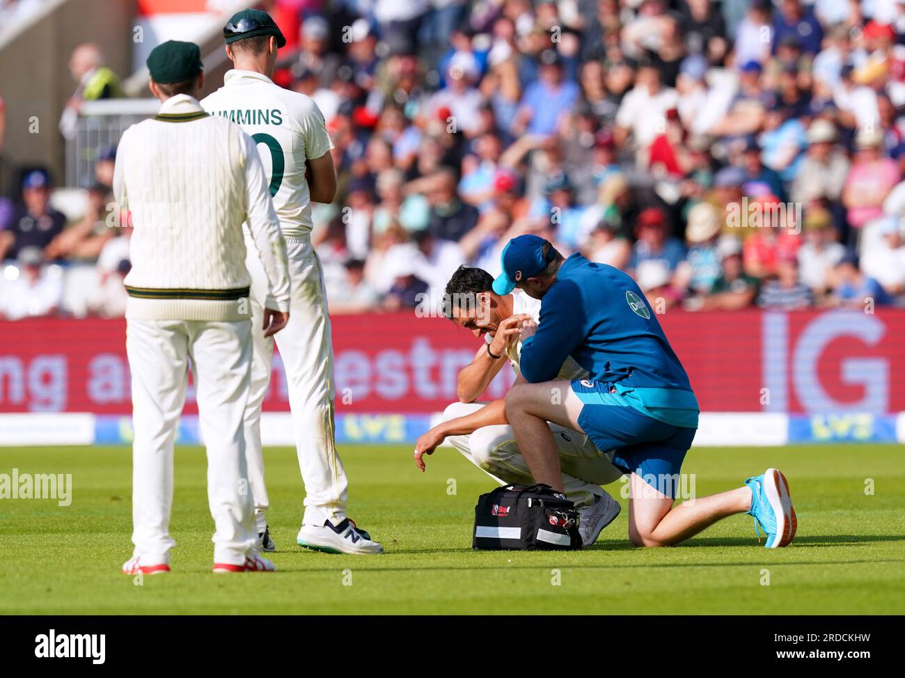 Australia's Mitchell Starc requires medical attention after picking up ...