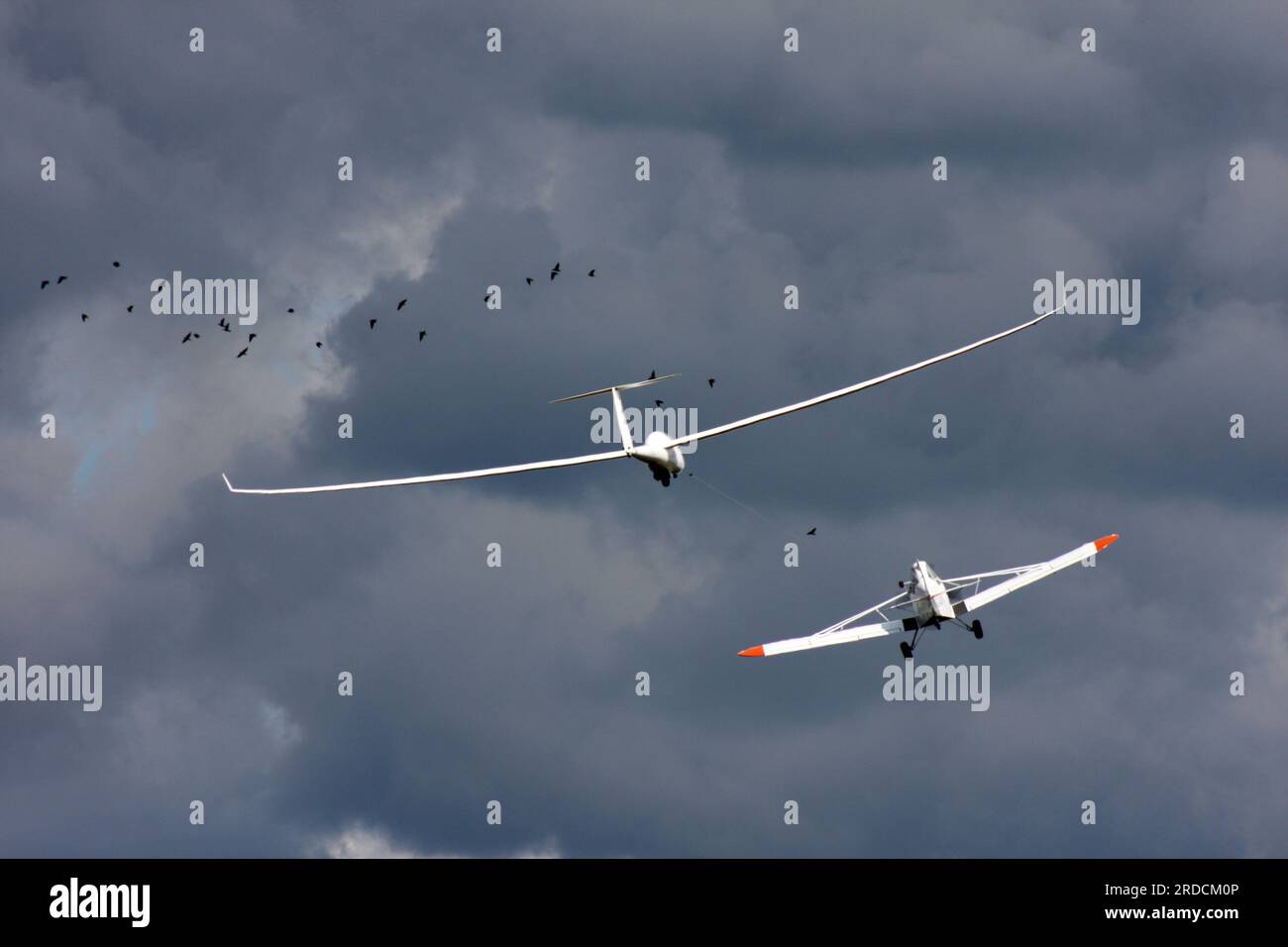 A glider being towed into the sky by a Piper Pawnee glider tug at a ...