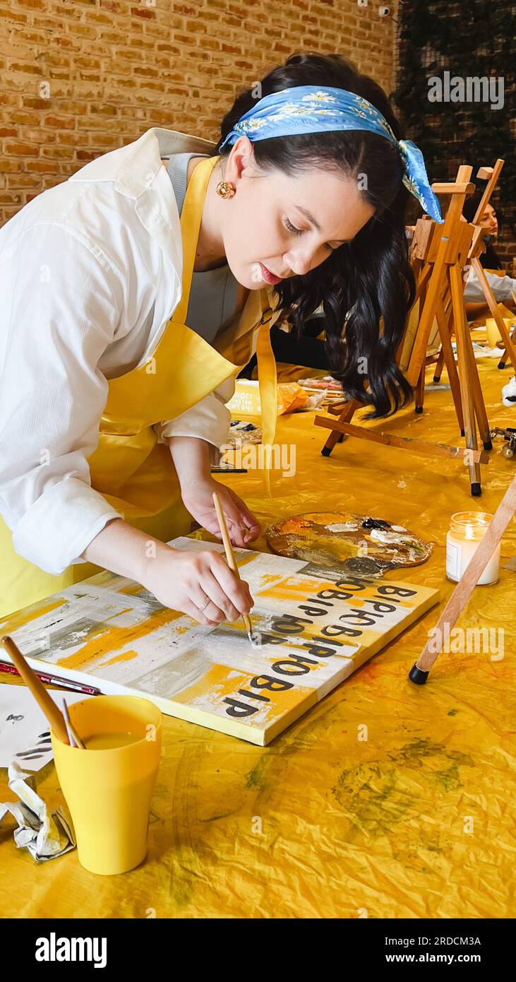 Woman paint brush canvas friends hi-res stock photography and images ...