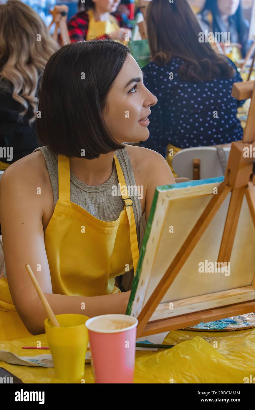Woman paint brush canvas friends hi-res stock photography and images ...