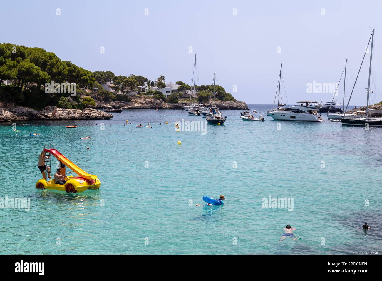 People enjoy the bay at the seaside resort of Cala d'Or on the Spanish ...
