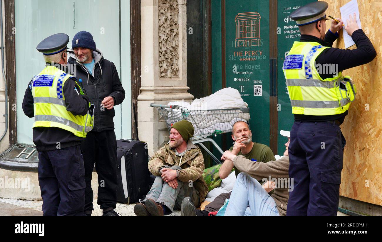 Two police officers chat to a group of homeless men who have been ...