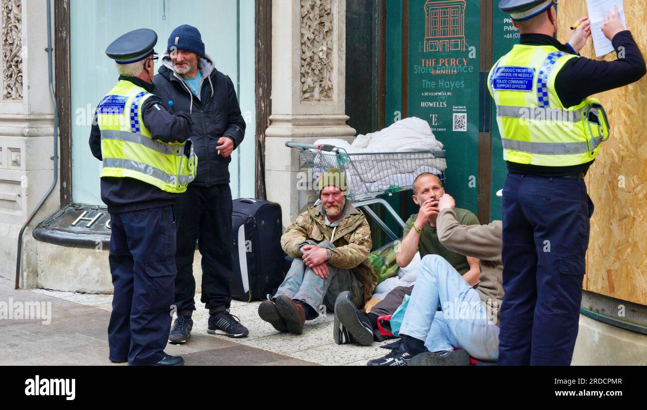 Two police officers chat to a group of homeless men who have been ...