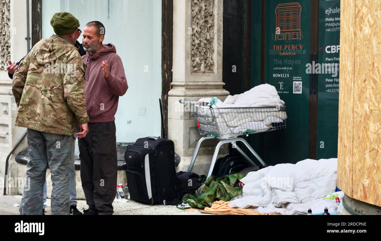 Three homeless men argue in the doorway of an empty department store on ...