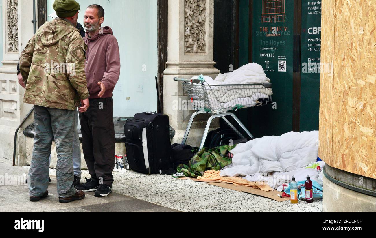 Three homeless men argue in the doorway of an empty department store on ...