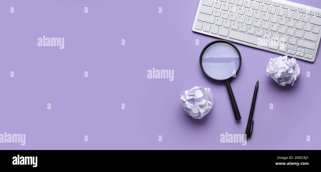 Crumpled paper sheets with computer keyboard, magnifier and pen on ...