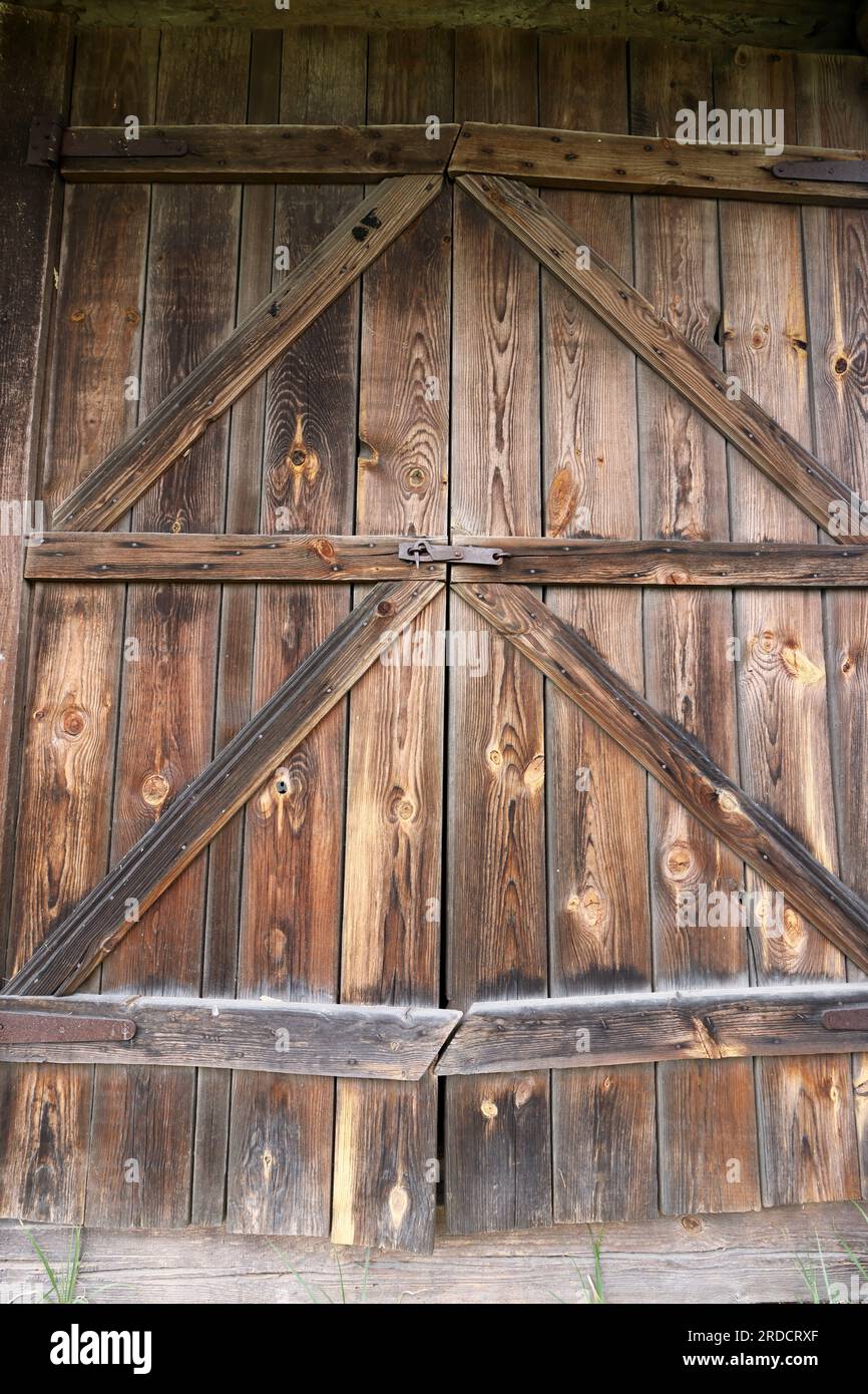 Old log shed. The gates are locked shut Stock Photo - Alamy
