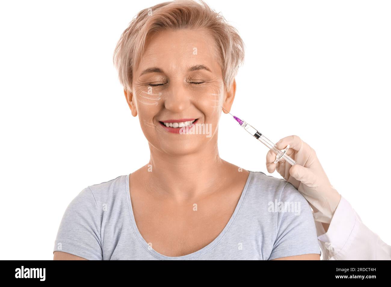 Mature woman receiving filler injection on white background, closeup ...