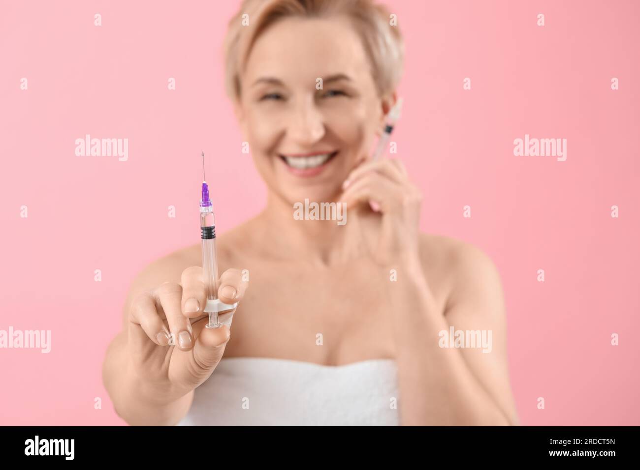 Mature woman with filler injections on pink background, closeup Stock ...