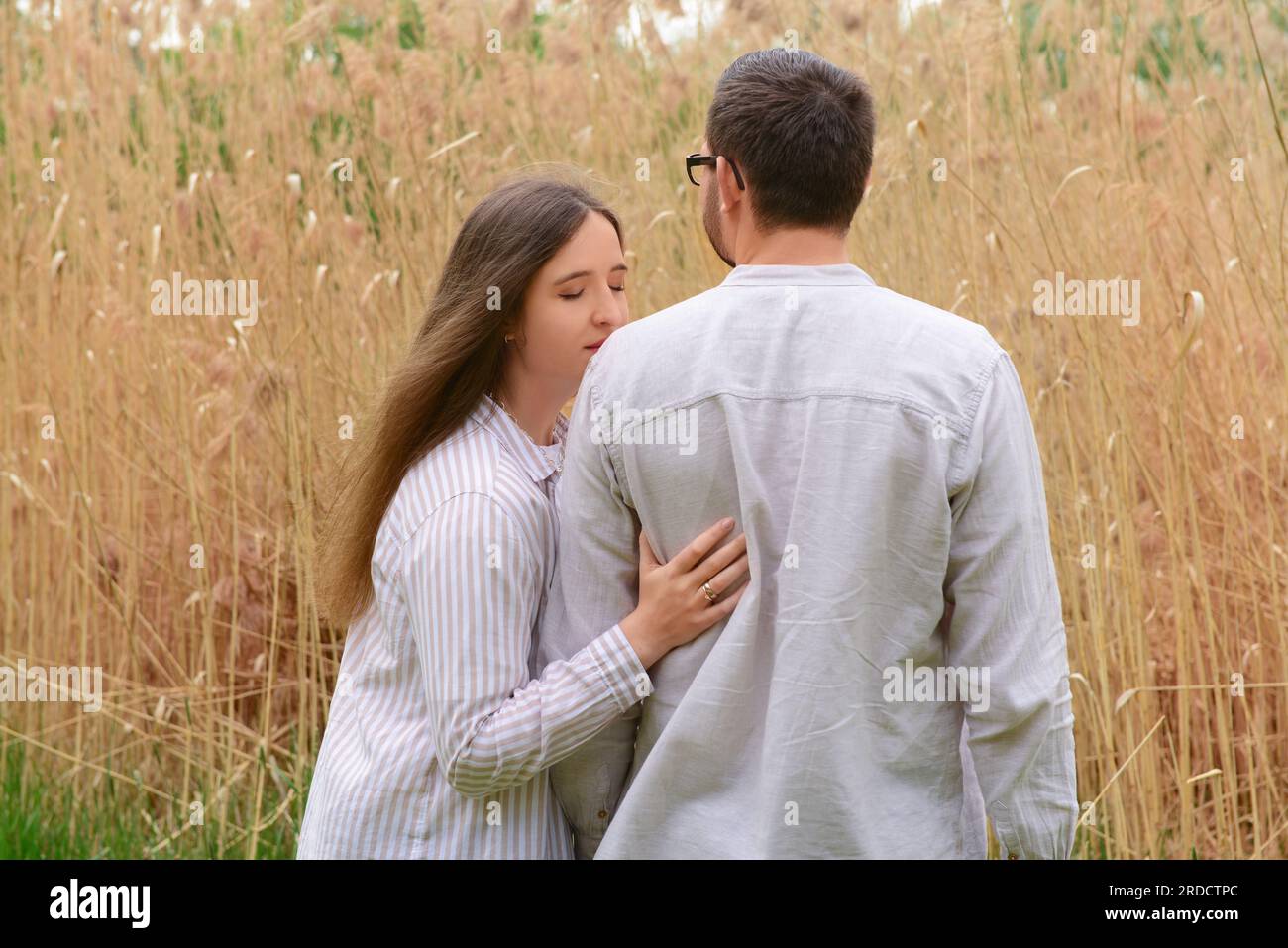 Beautiful happy loving couple hugging in field on spring day Stock ...