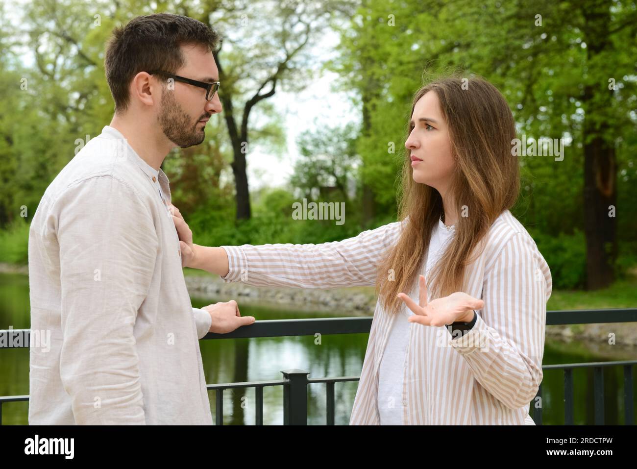 Beautiful couple arguing on bridge in park Stock Photo - Alamy