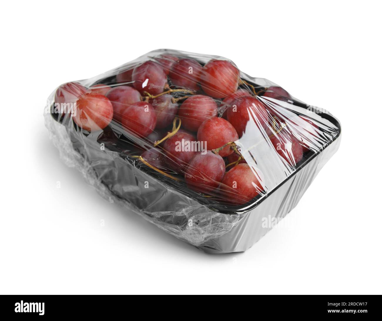 Plastic package with ripe red grapes on white background Stock Photo ...