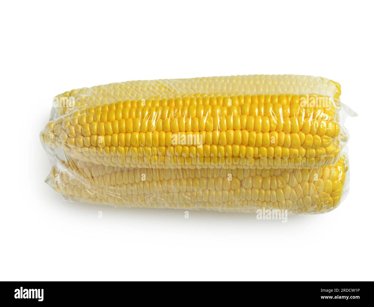 Corn in plastic food wrap on white background Stock Photo - Alamy