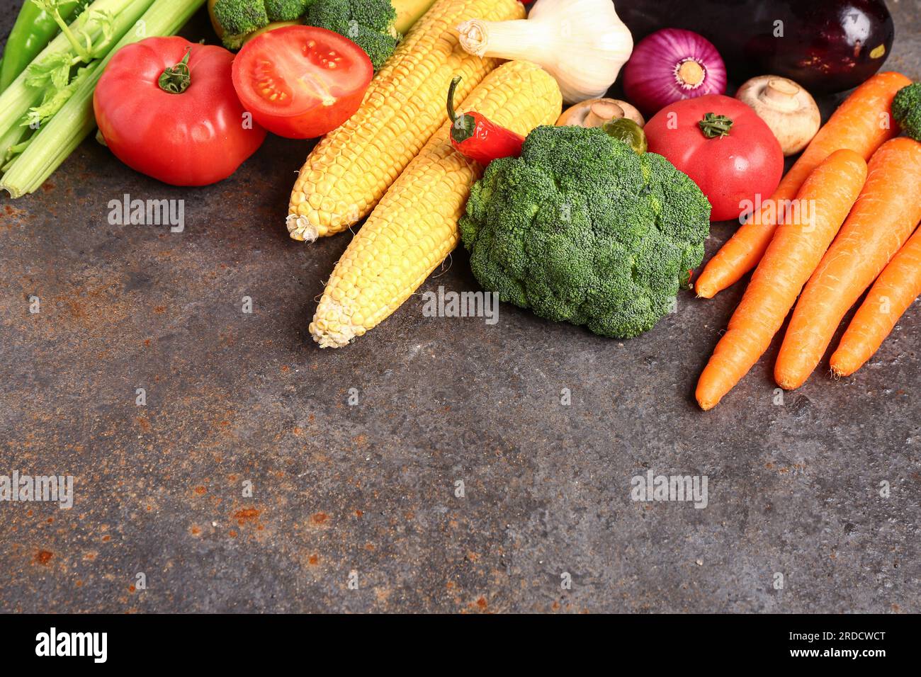 Different fresh vegetables on dark background Stock Photo - Alamy