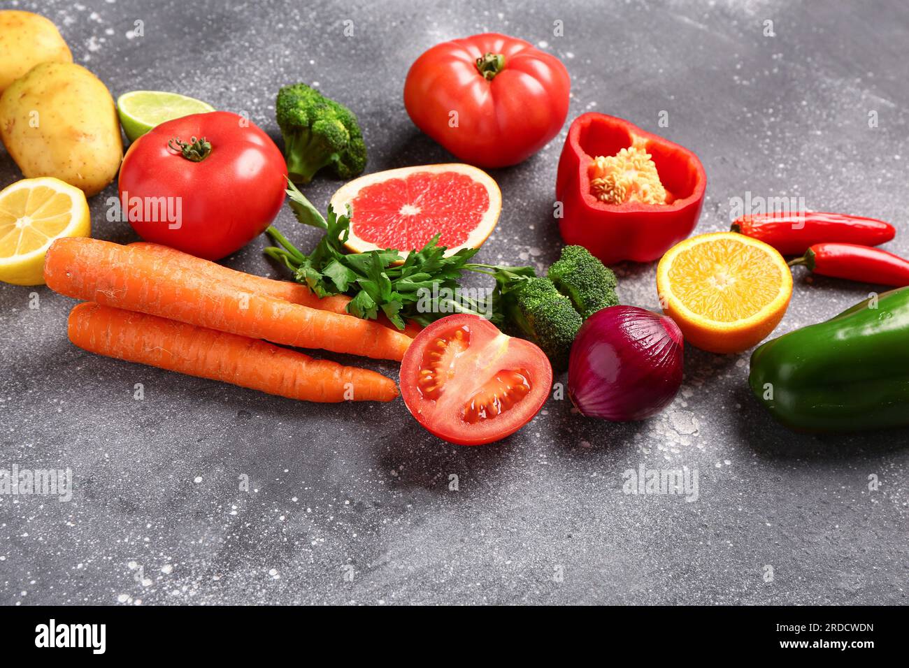 Different fresh vegetables on grey background Stock Photo - Alamy
