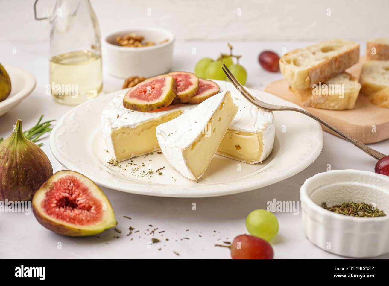 Plate with pieces of tasty Camembert cheese on grey background Stock ...