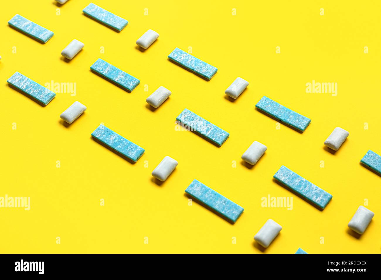 Fresh chewing gums on yellow background Stock Photo - Alamy