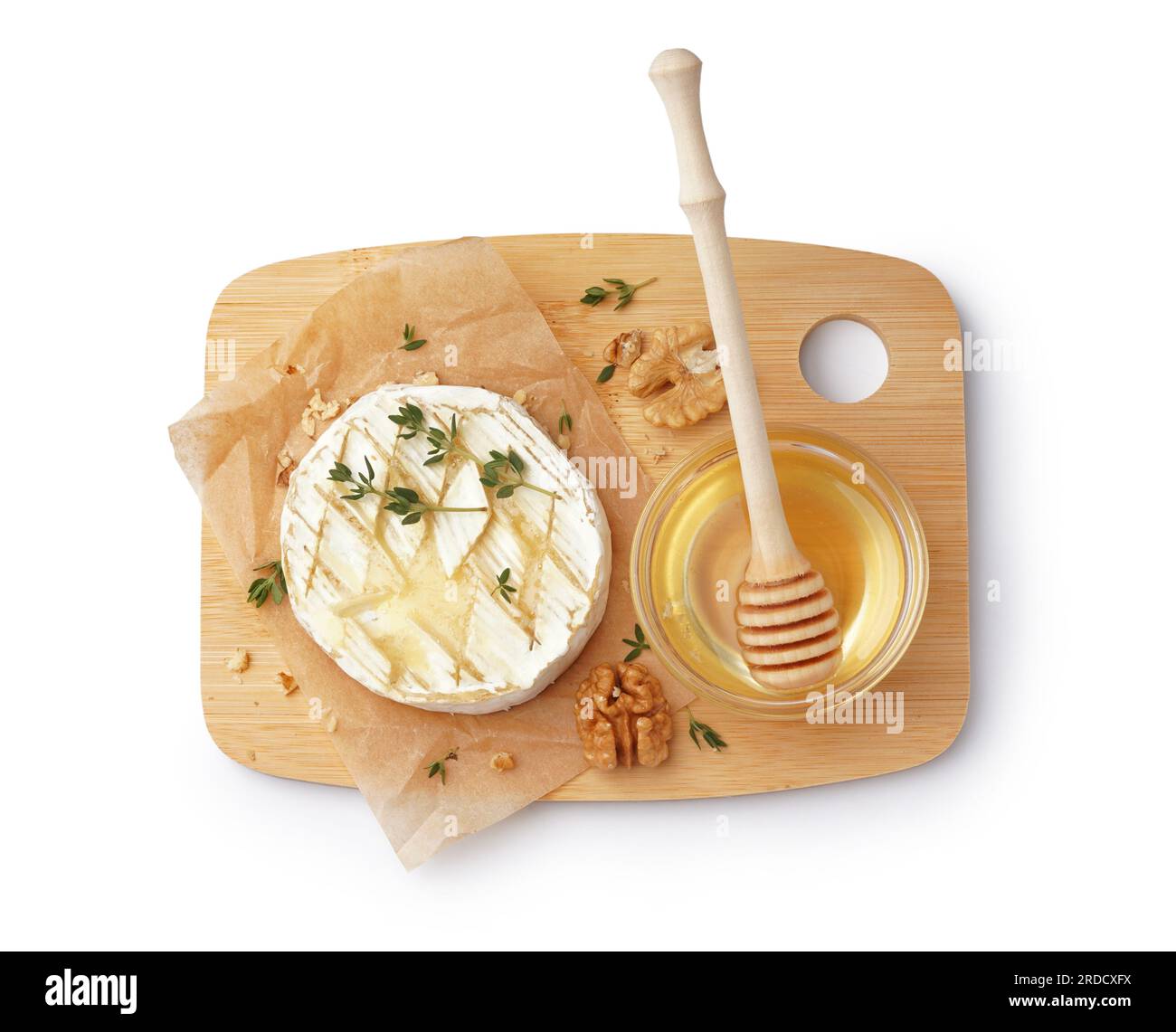 Wooden board of tasty baked Camembert cheese with honey on white ...