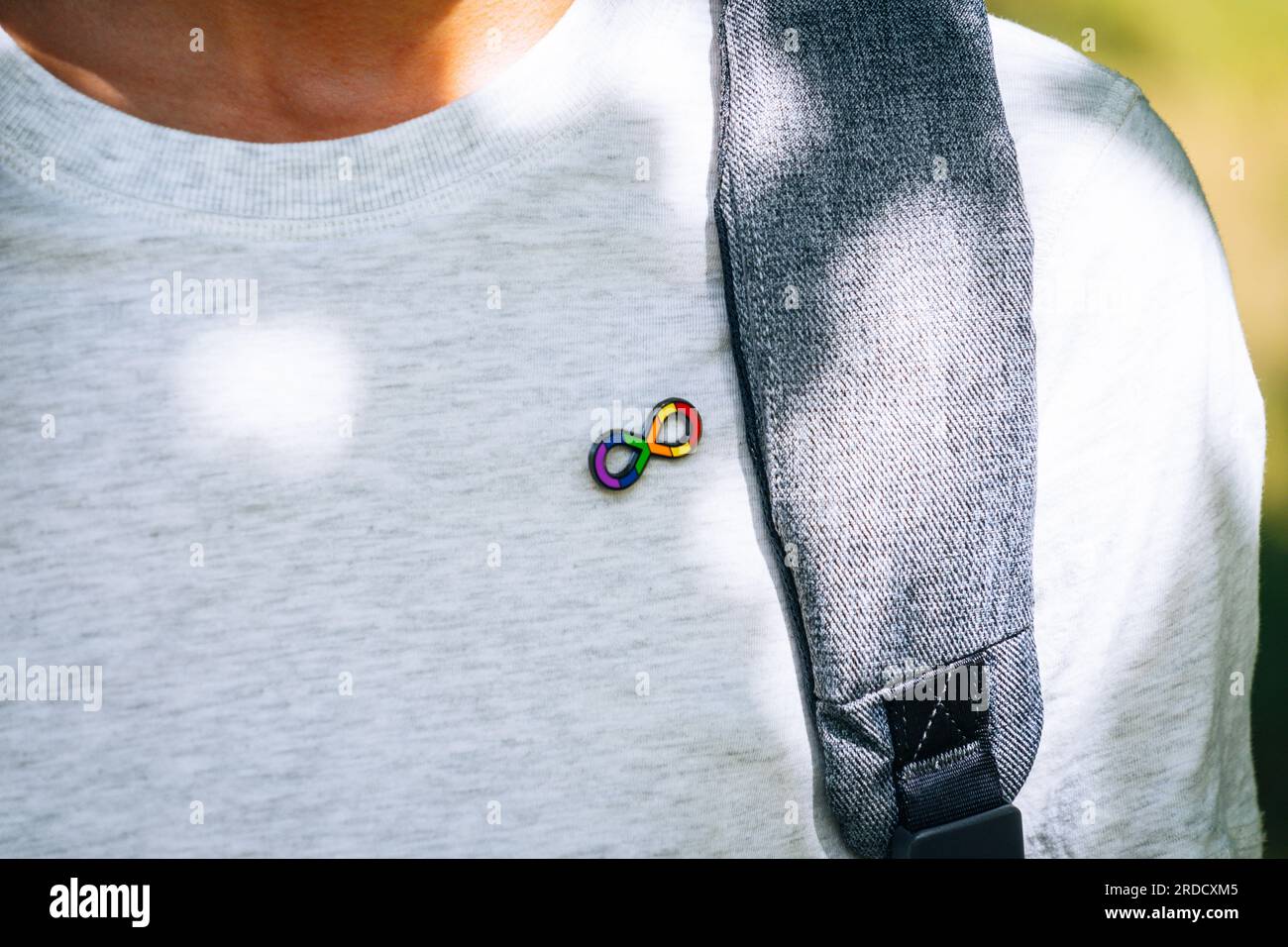 Adolescent boy with backpack with autism infinity rainbow symbol sign ...