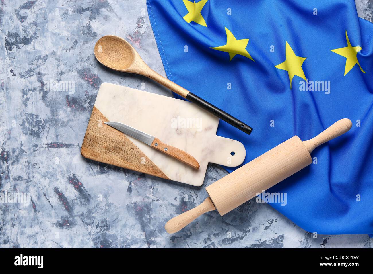 Flag of European Union with kitchen utensils on grey grunge background ...
