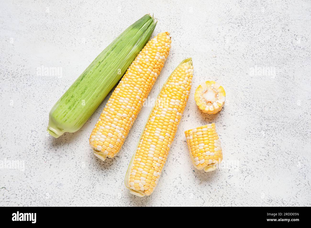 Fresh corn cobs on light background Stock Photo - Alamy