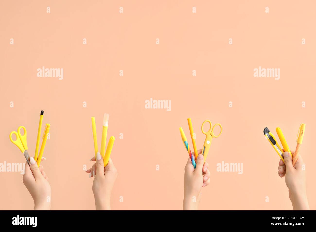 Female hands with school supplies on beige background Stock Photo - Alamy