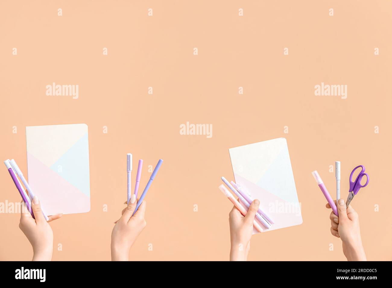 Female hands with school supplies on beige background Stock Photo - Alamy