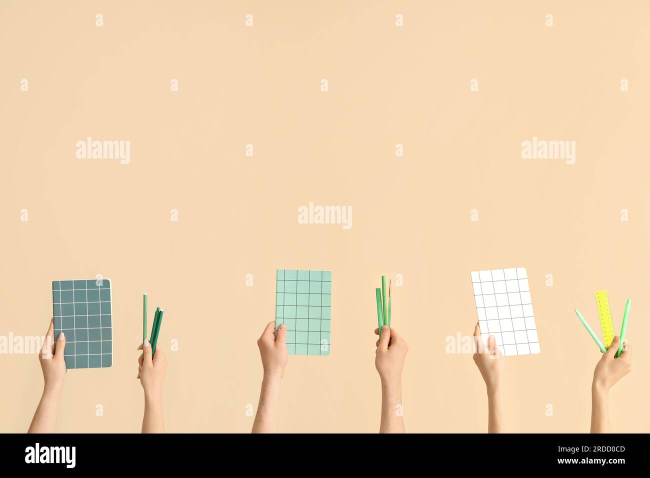 Hands with school supplies on beige background Stock Photo - Alamy