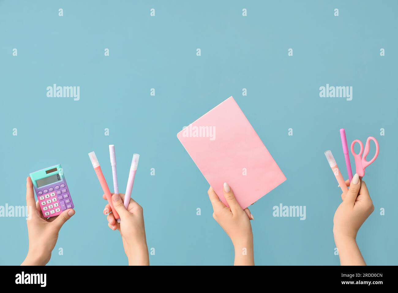 Female hands with school supplies on blue background Stock Photo - Alamy