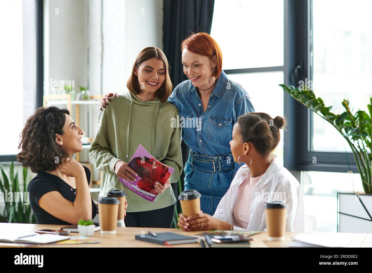 optimistic redhead woman hugging young girlfriend standing with ...