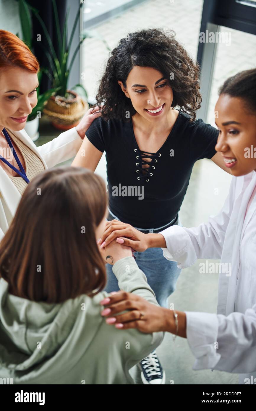 Young multiracial people joining hands hi-res stock photography and ...