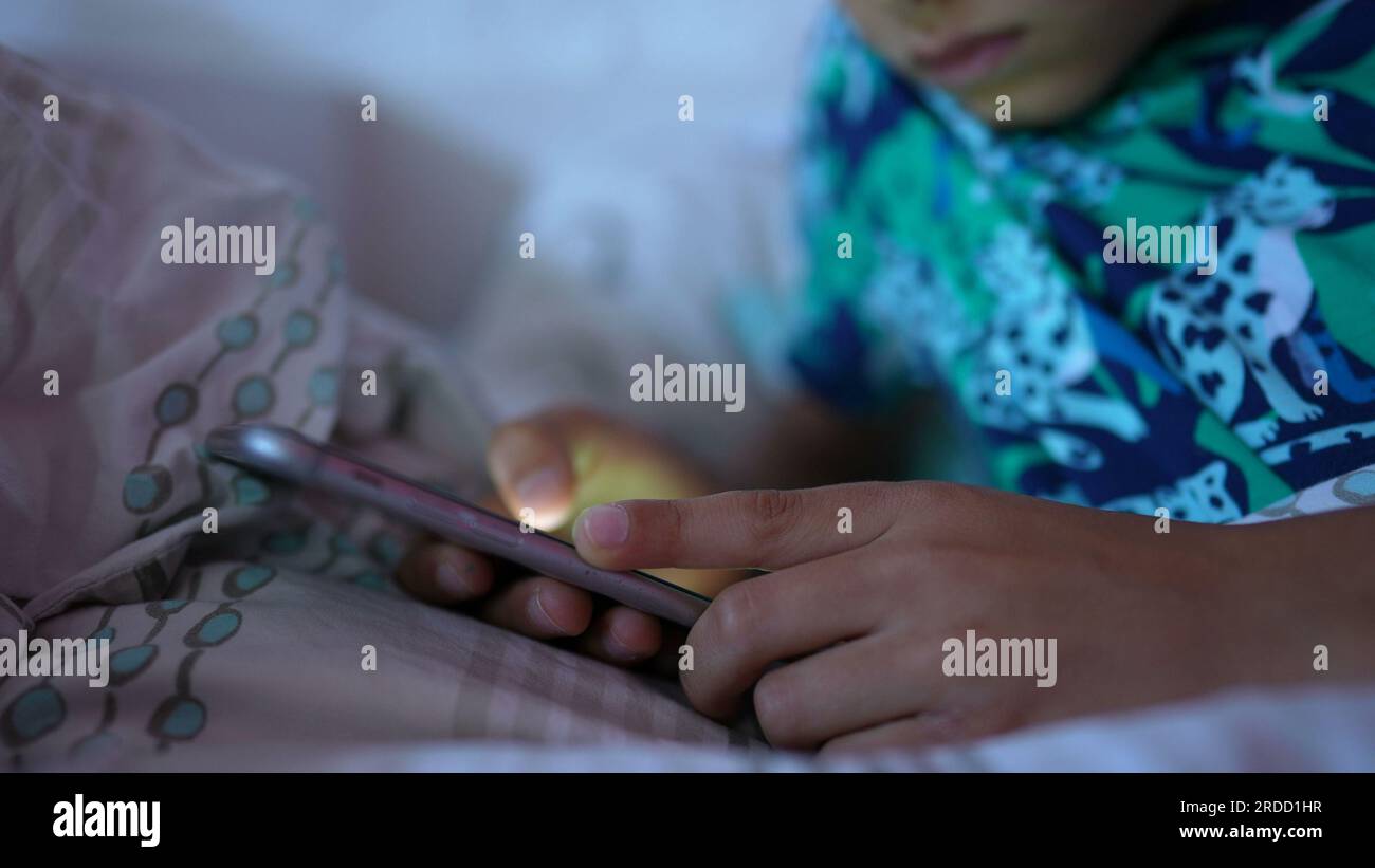 Child scrolling through phone screen in morning bed Stock Photo - Alamy Child scrolling through phone screen in morning bed Stock Photo - Alamy