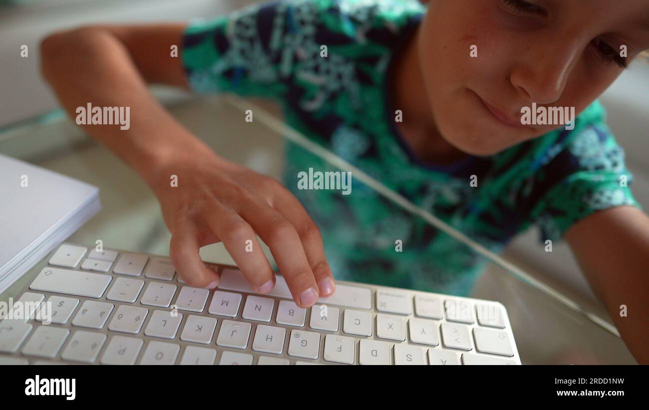 Child using computer keyboard typing space key Stock Photo - Alamy